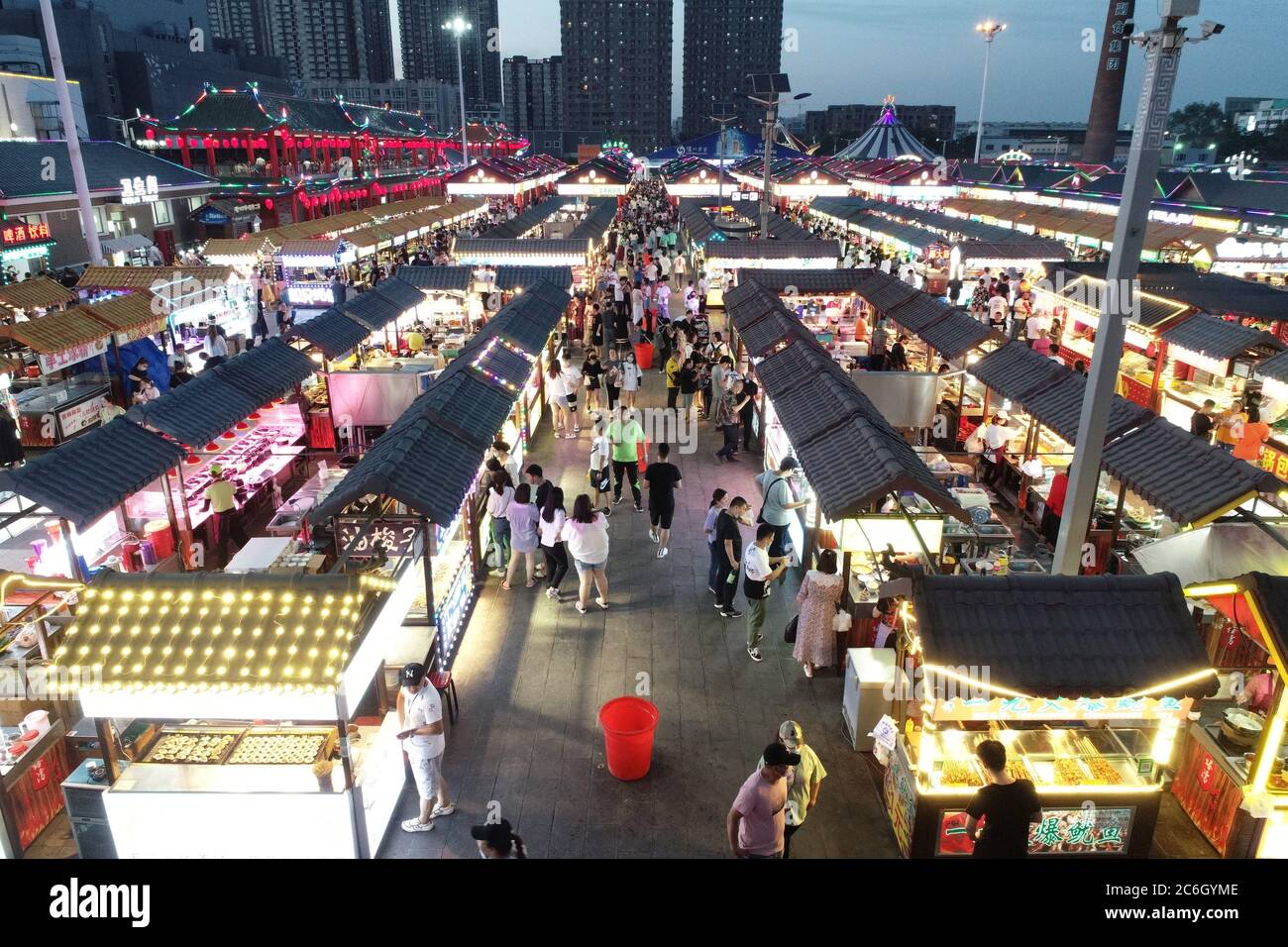 An aerial view of tourists wandering among and buying food from snack ...