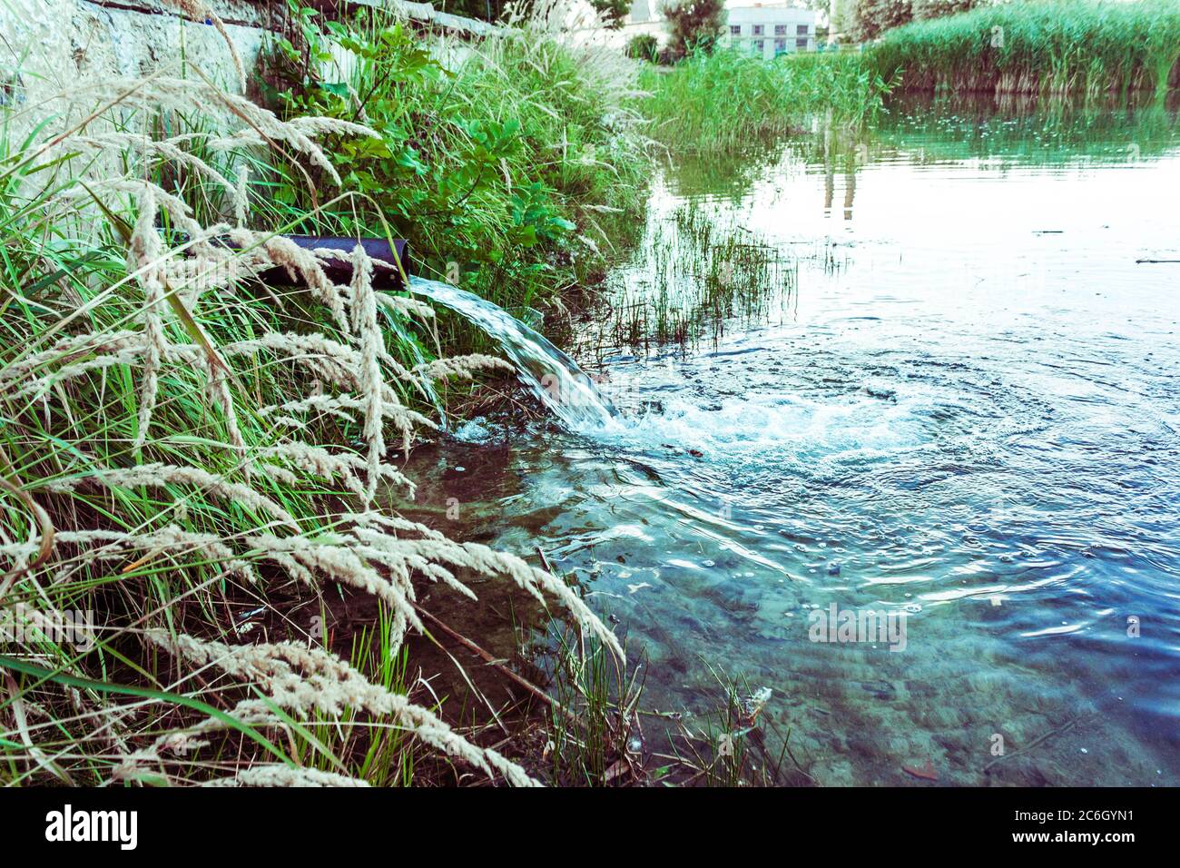 Sewage flows into the lake, river. Water flows from the pipes ...
