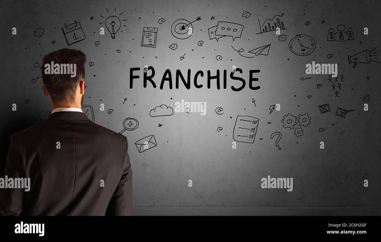 businessman drawing a creative idea sketch with FRANCHISE inscription ...