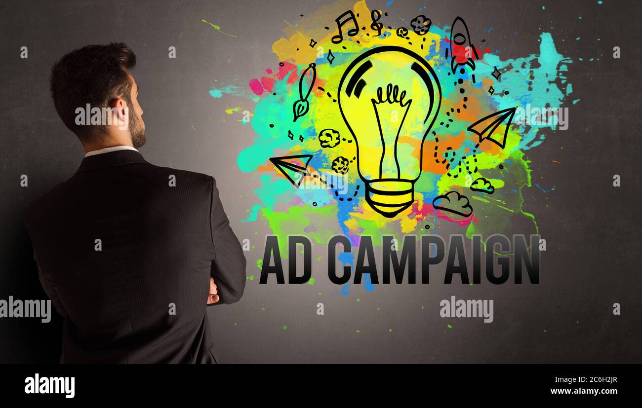 businessman drawing colorful light bulb with AD CAMPAIGN inscription on ...