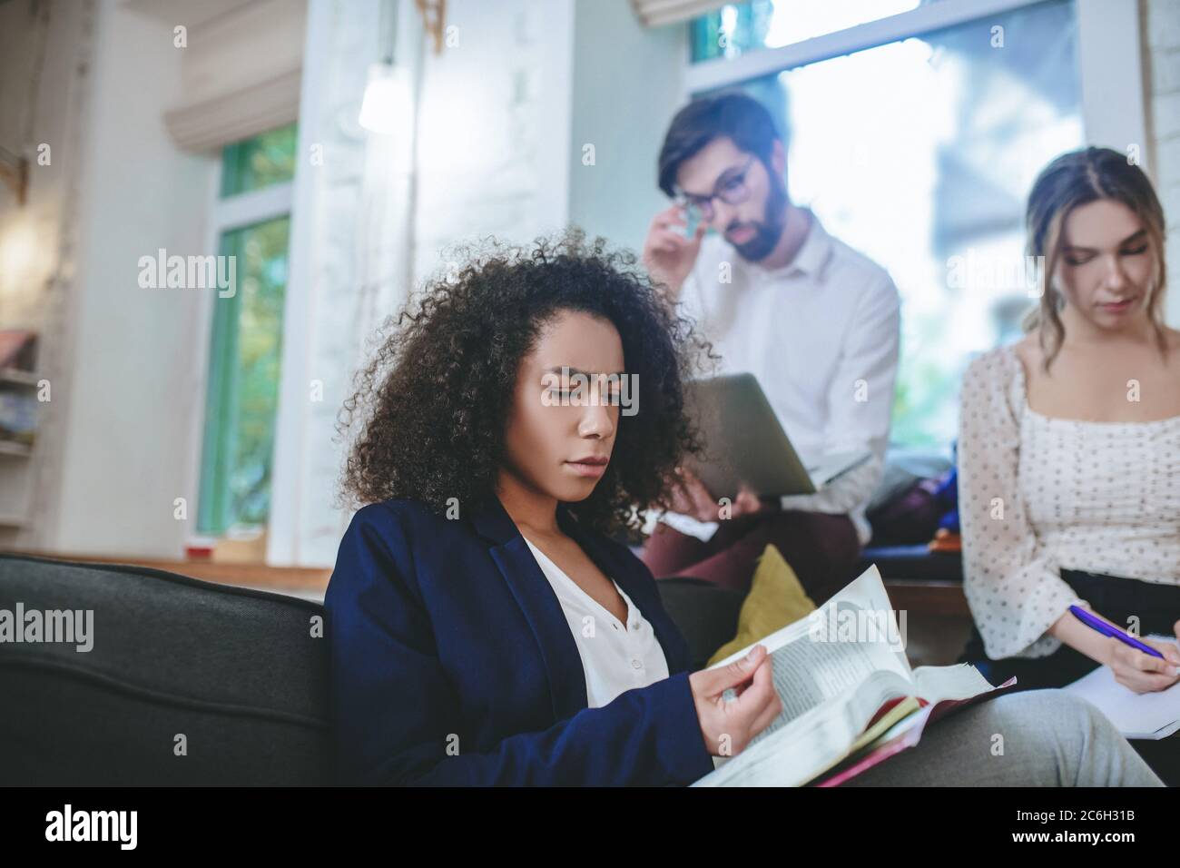 Girl with a book, girlfriend writing in notebooks, boyfriend with ...