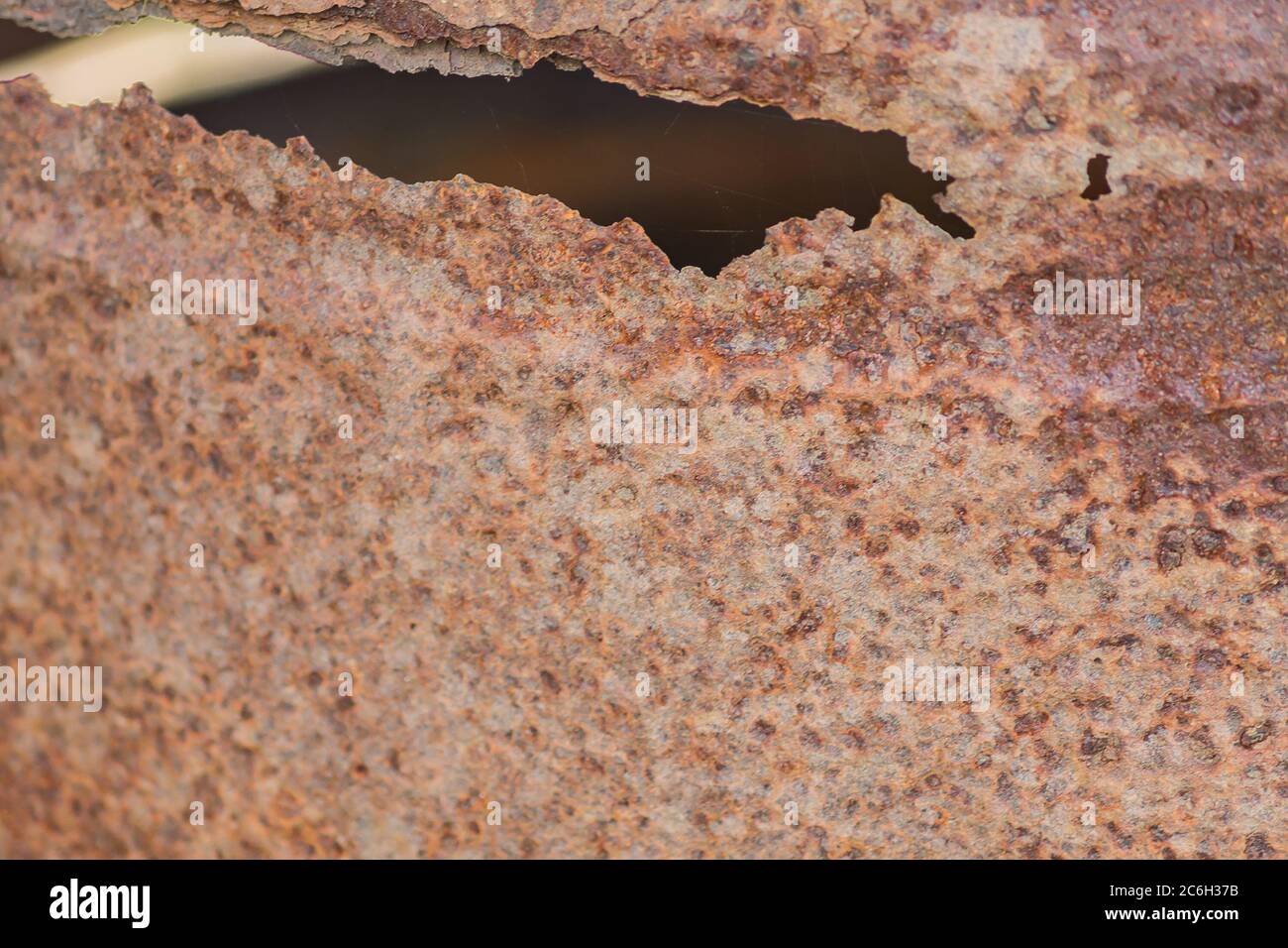 Hole in rusty iron background Stock Photo - Alamy