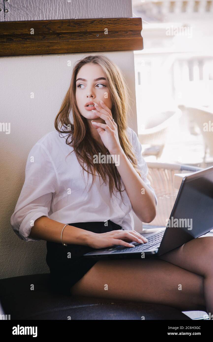 Photo of affable woman with long brown hair holding silver personal ...
