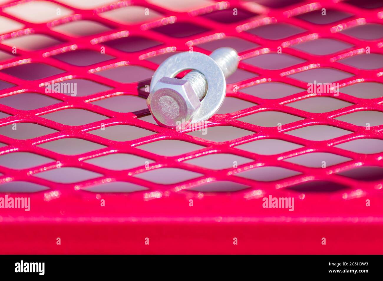 screw and nut lying on red metal grill, closeup Stock Photo - Alamy