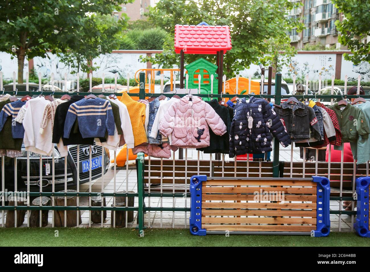 Kids' clothes are displayed for sell at a kindergarten school ...