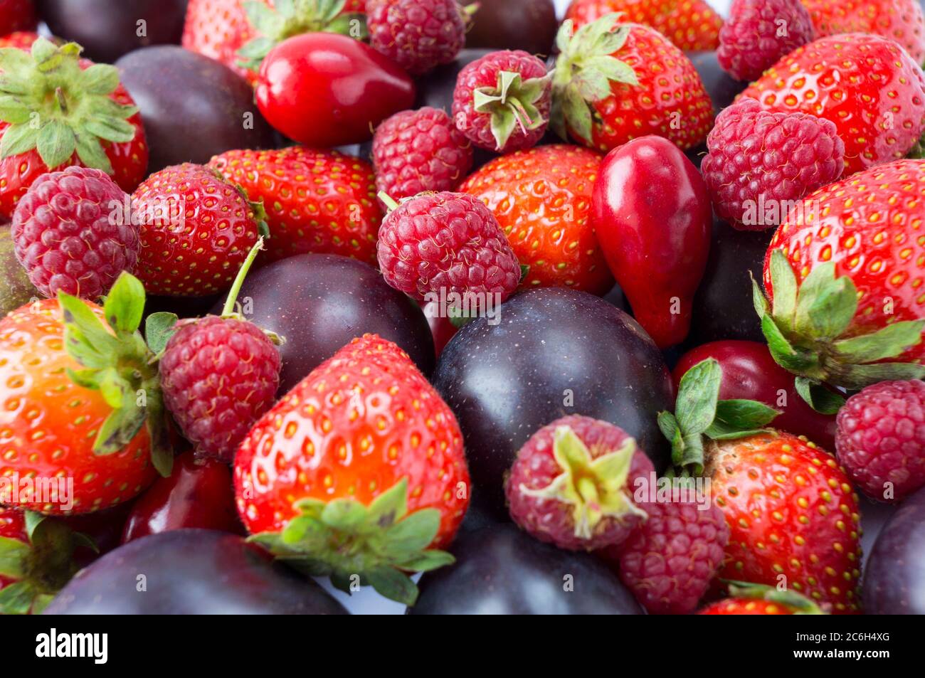 Various fresh summer fruits. Ripe strawberries, raspberries, red ...