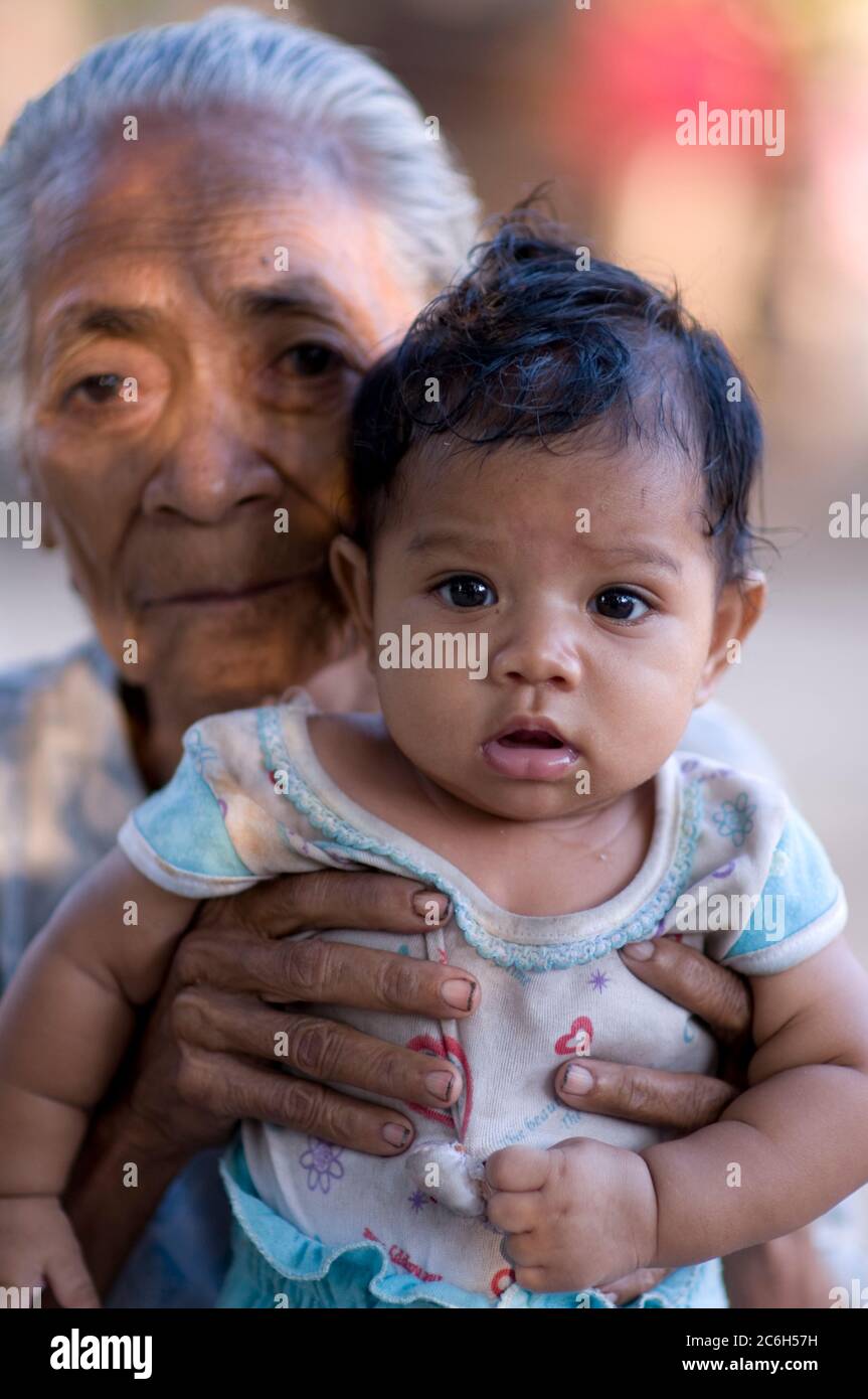 Grandmother holding grandchild, Uhak Village, North Wetar Island, near ...