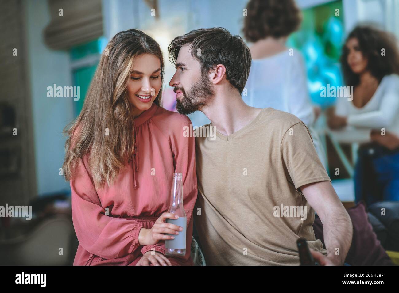 Guy showing sympathy for smiling girl, friends at distance Stock Photo ...