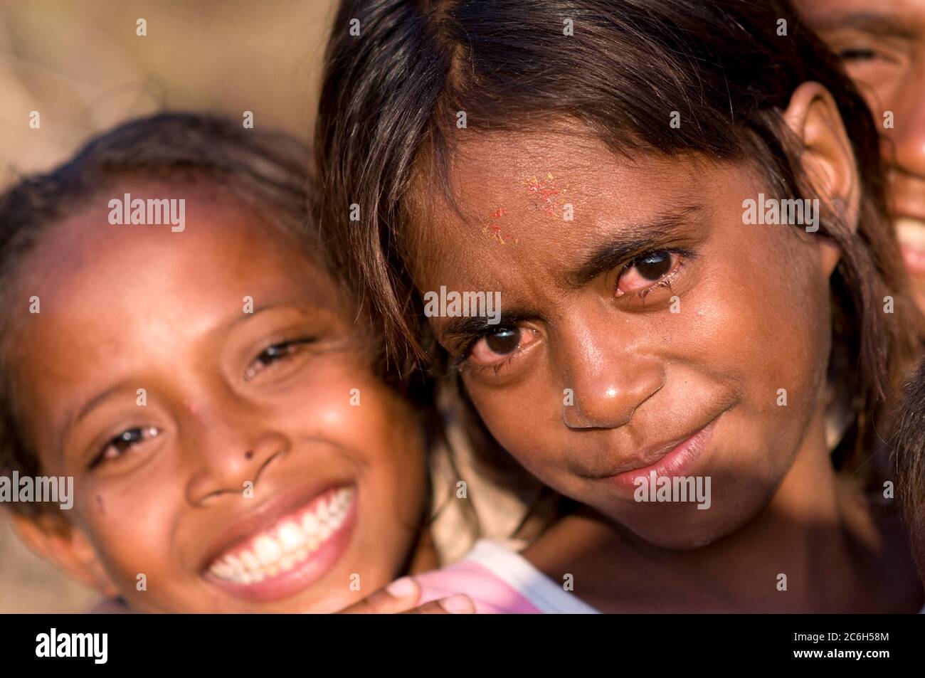 Two girls smiling, Uhak Village, North Wetar Island, near Alor, Maluku ...