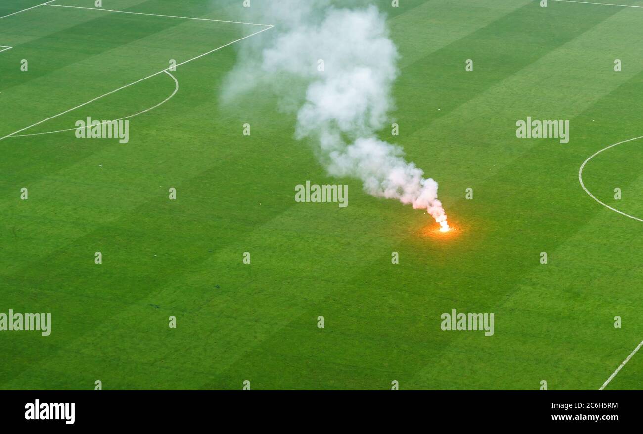 Burning flare on football pitch Stock Photo - Alamy