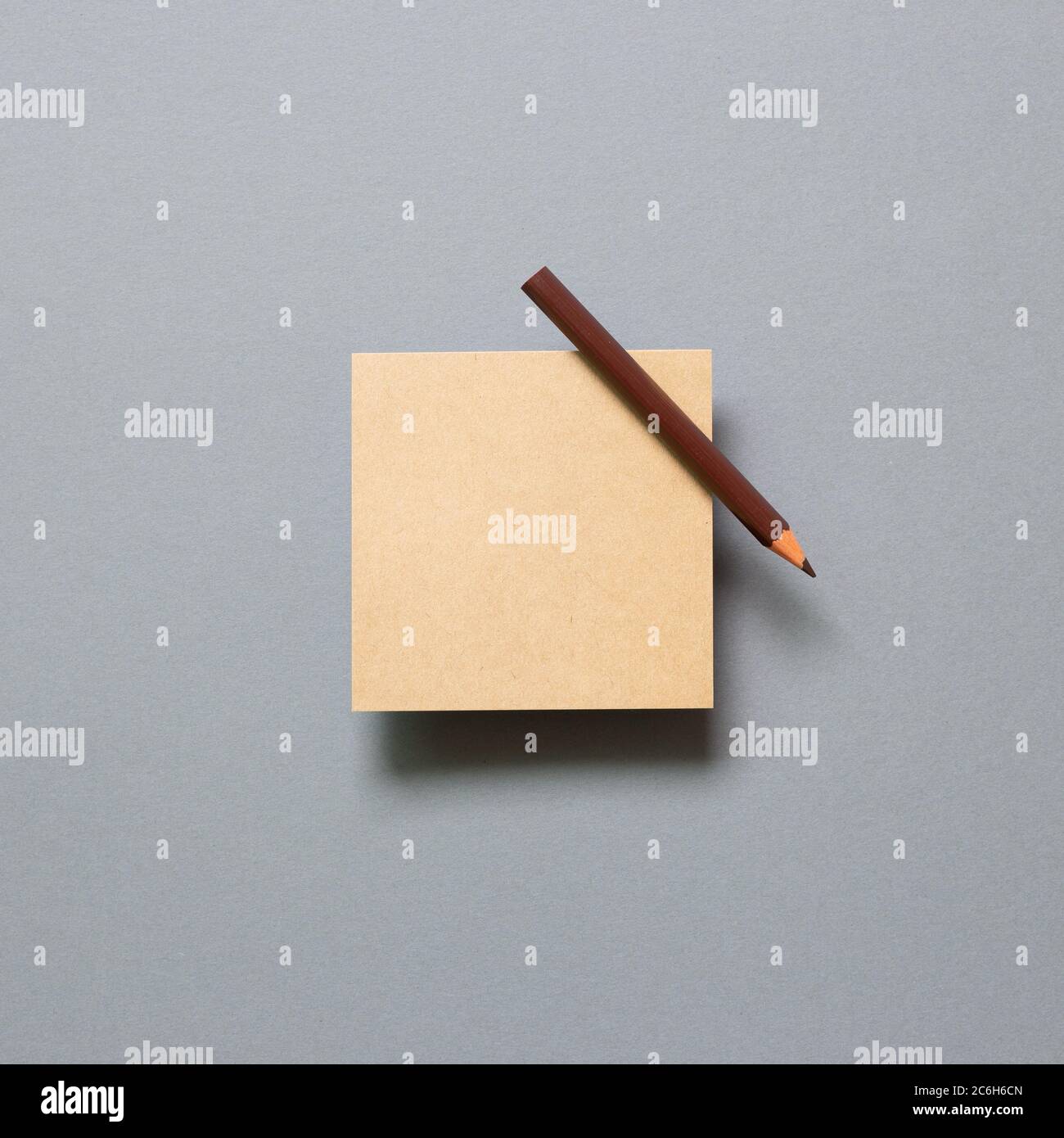 Brown kraft memo pad, empty paper with colored pencil on gray ...