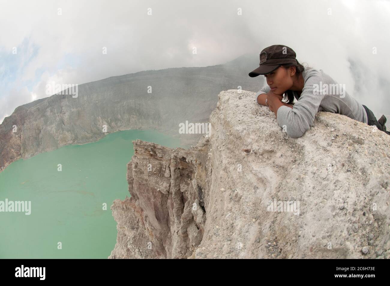 Woman tourist looking at turquoise-green coloured lake and side of ...