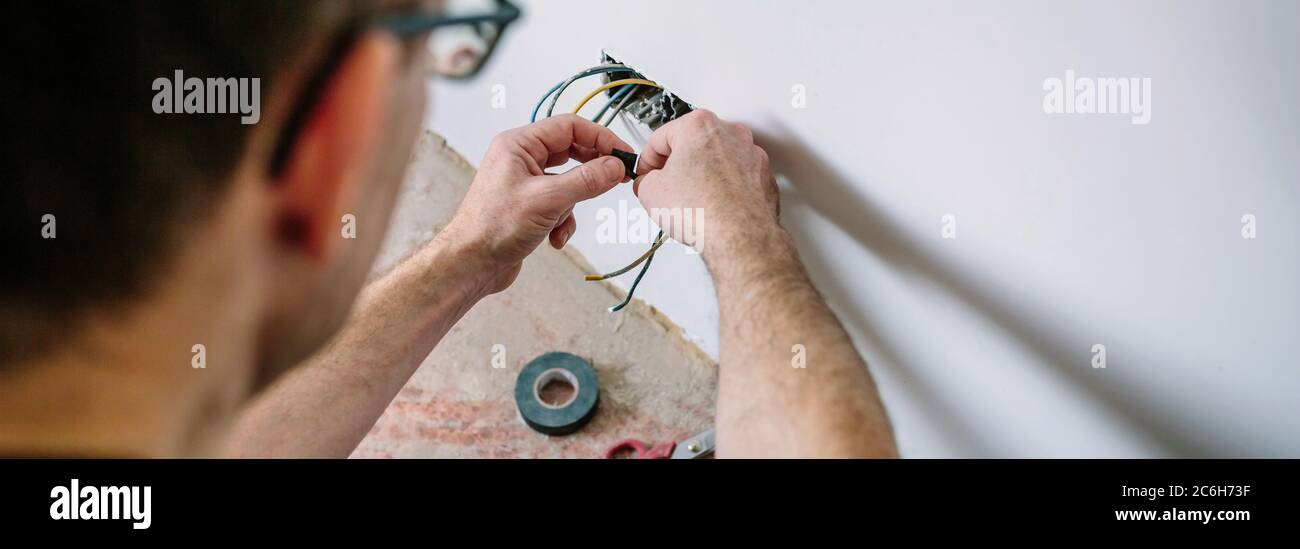 Electrician working on the electrical installation of a house Stock ...