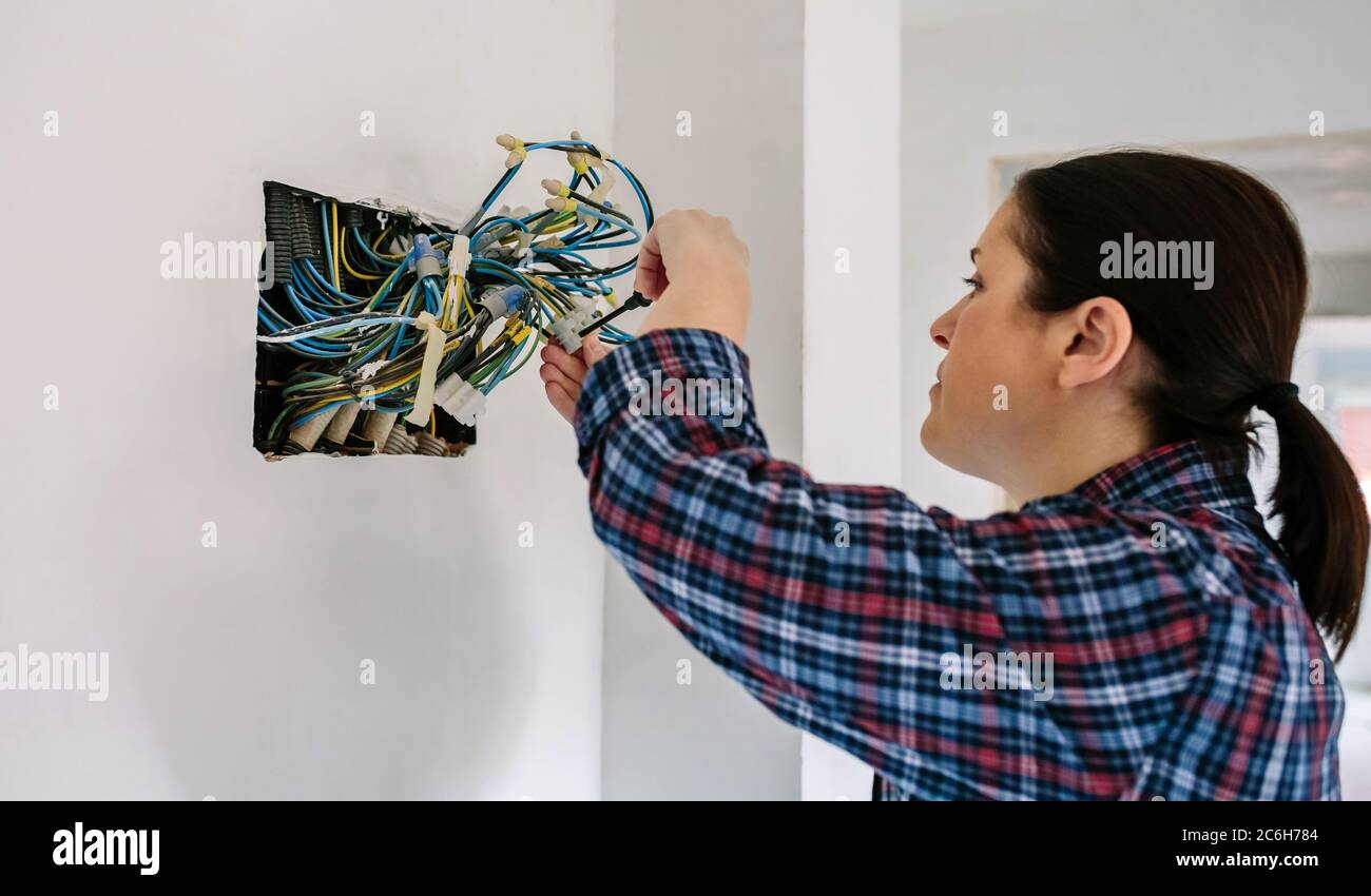 Electrician working on the electrical installation of a house Stock ...