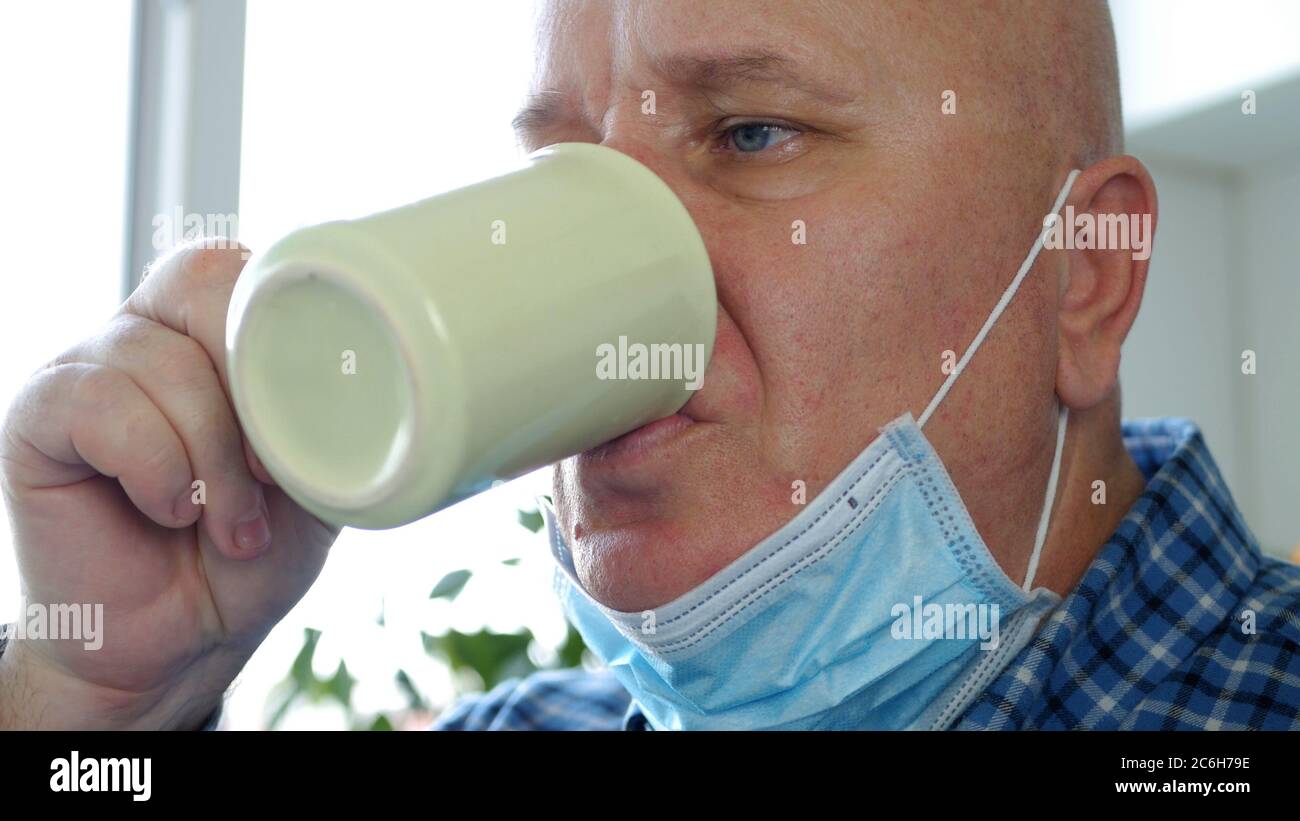 Image with Man Wearing Protection Mask on His Face Drinking a Cup with ...