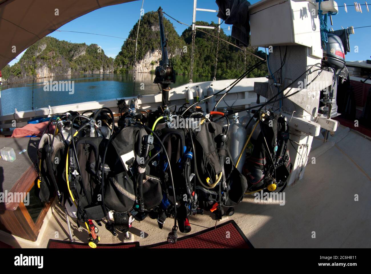 Scuba tanks on diving liveaboard boat with limestone pinnacle islands ...