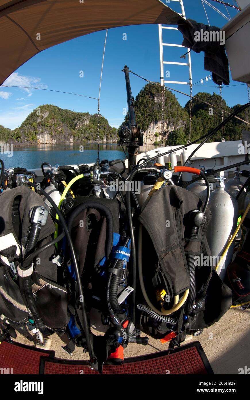 Scuba tanks on diving liveaboard boat with limestone pinnacle islands ...
