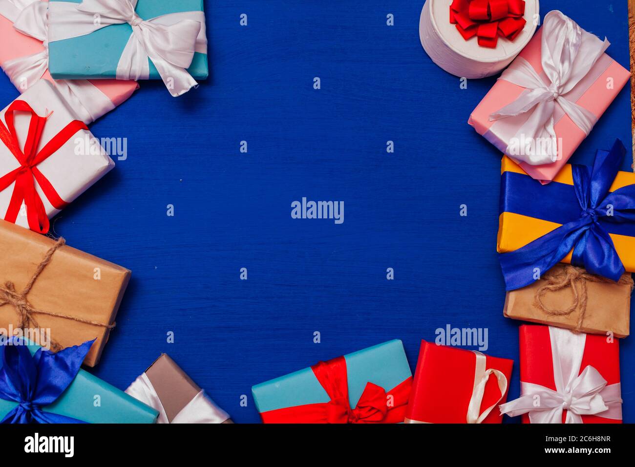 many beautiful gifts of different colors on holiday on a blue ...