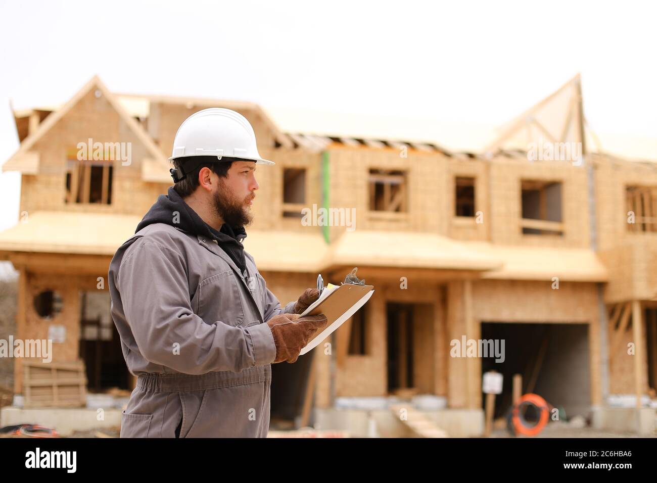 Builder drawing plan in notebook at construction site Stock Photo - Alamy
