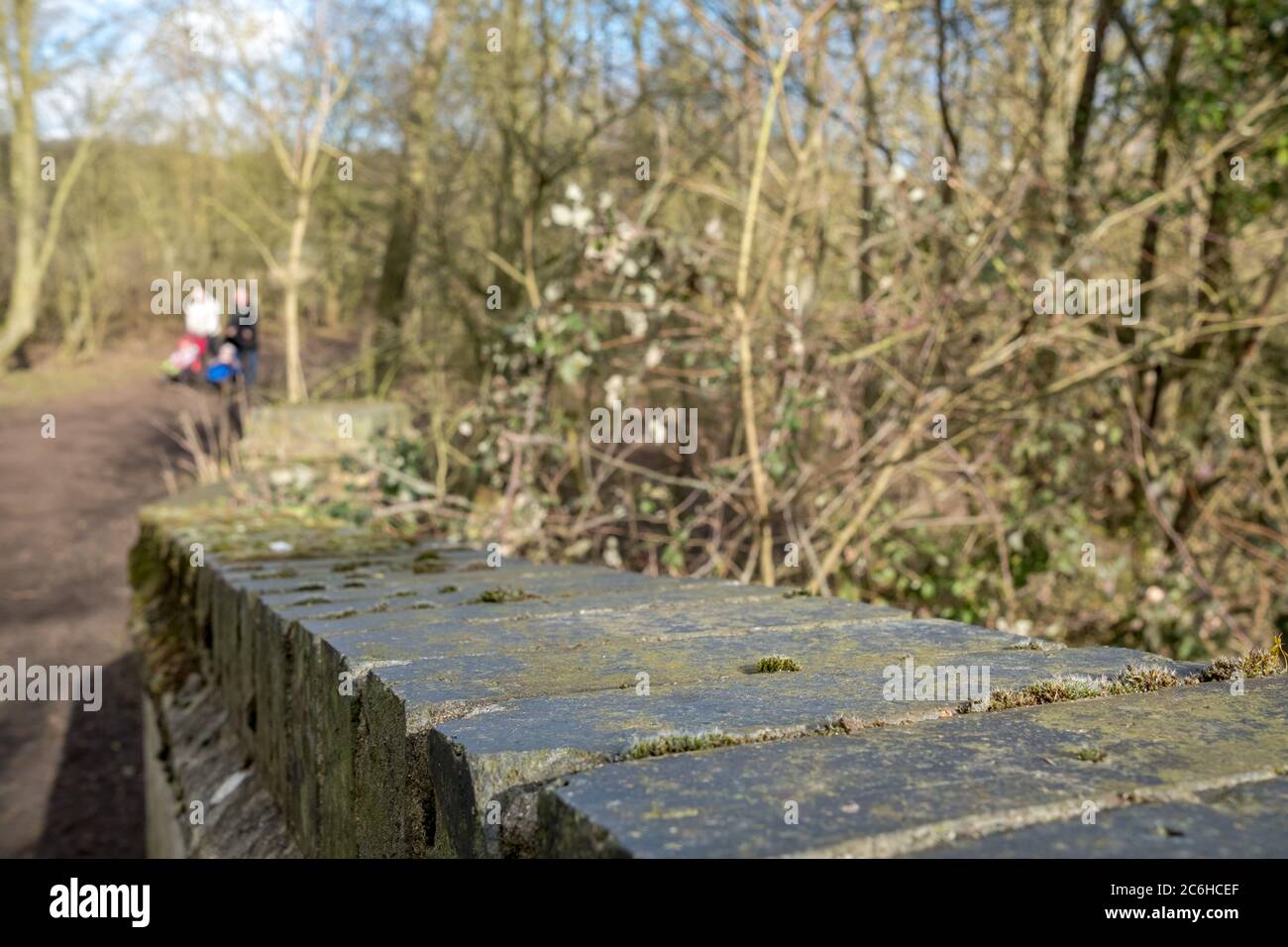 Close-up image of an old and weathered brick built foot bridge crossing ...