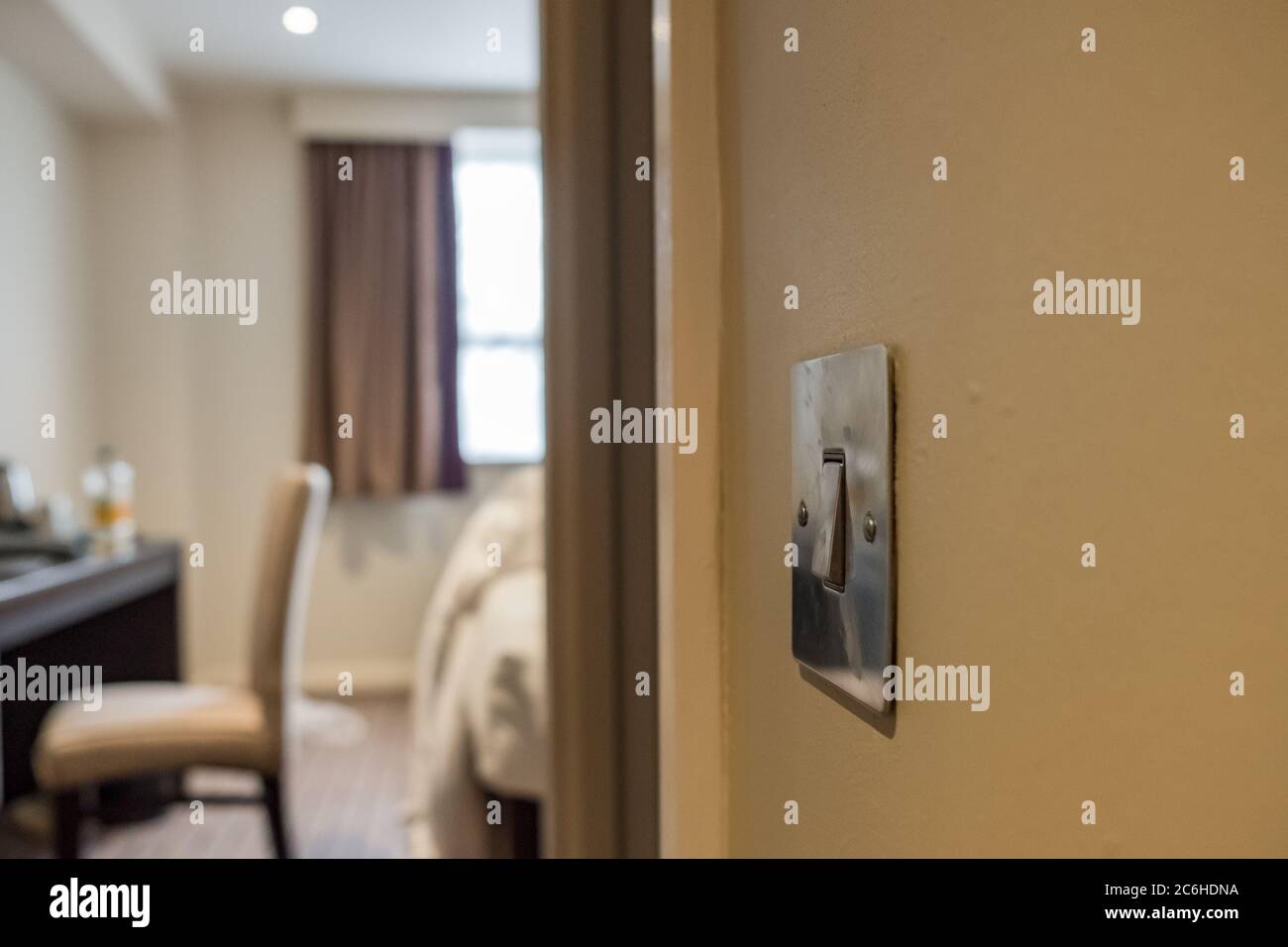 Isolated view of a metal light switch in the office position located in ...