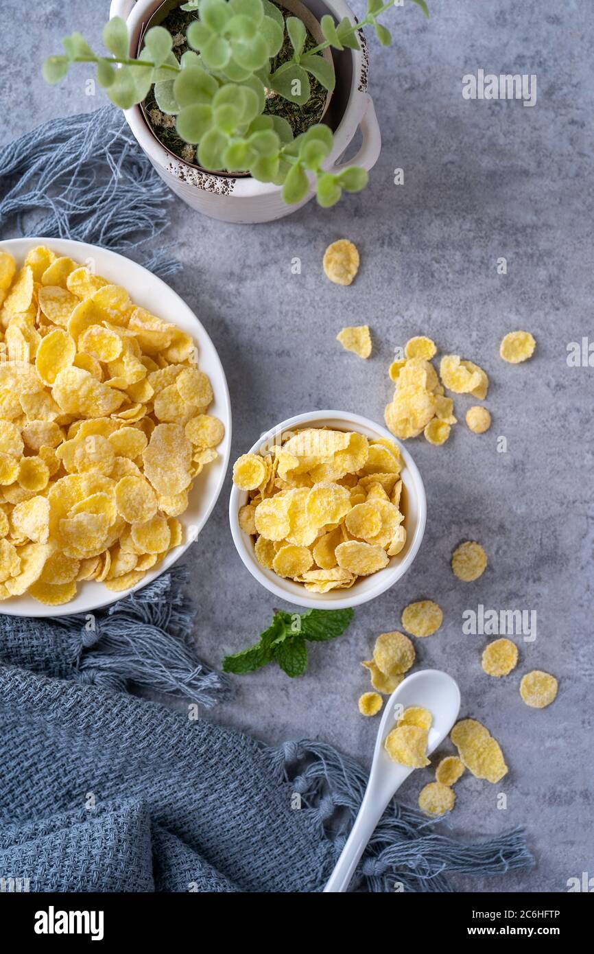 Corn flakes bowl sweets on gray cement background, top view flat lay layout design, fresh and ...