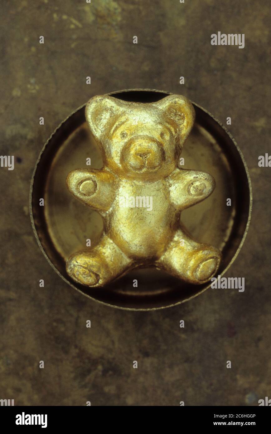 Small model of solid teddy bear painted gold and sitting with arms ...