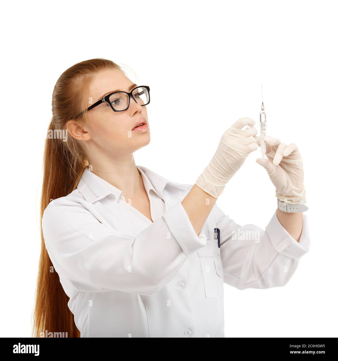 Portrait of an attractive young woman doctor with a syringe in his hand ...