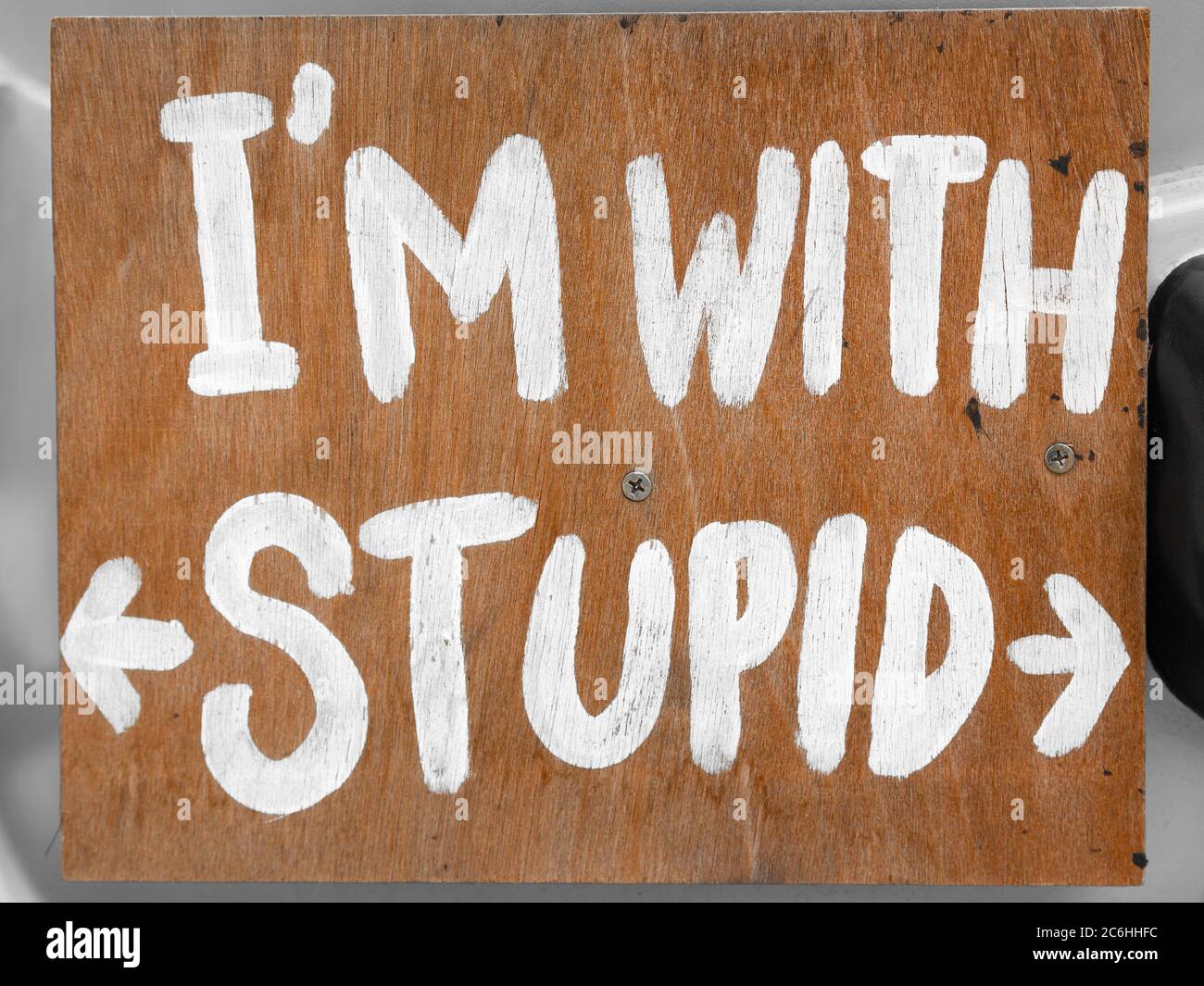 Wooden board with I'm With Stupid sign written in white paint Stock ...