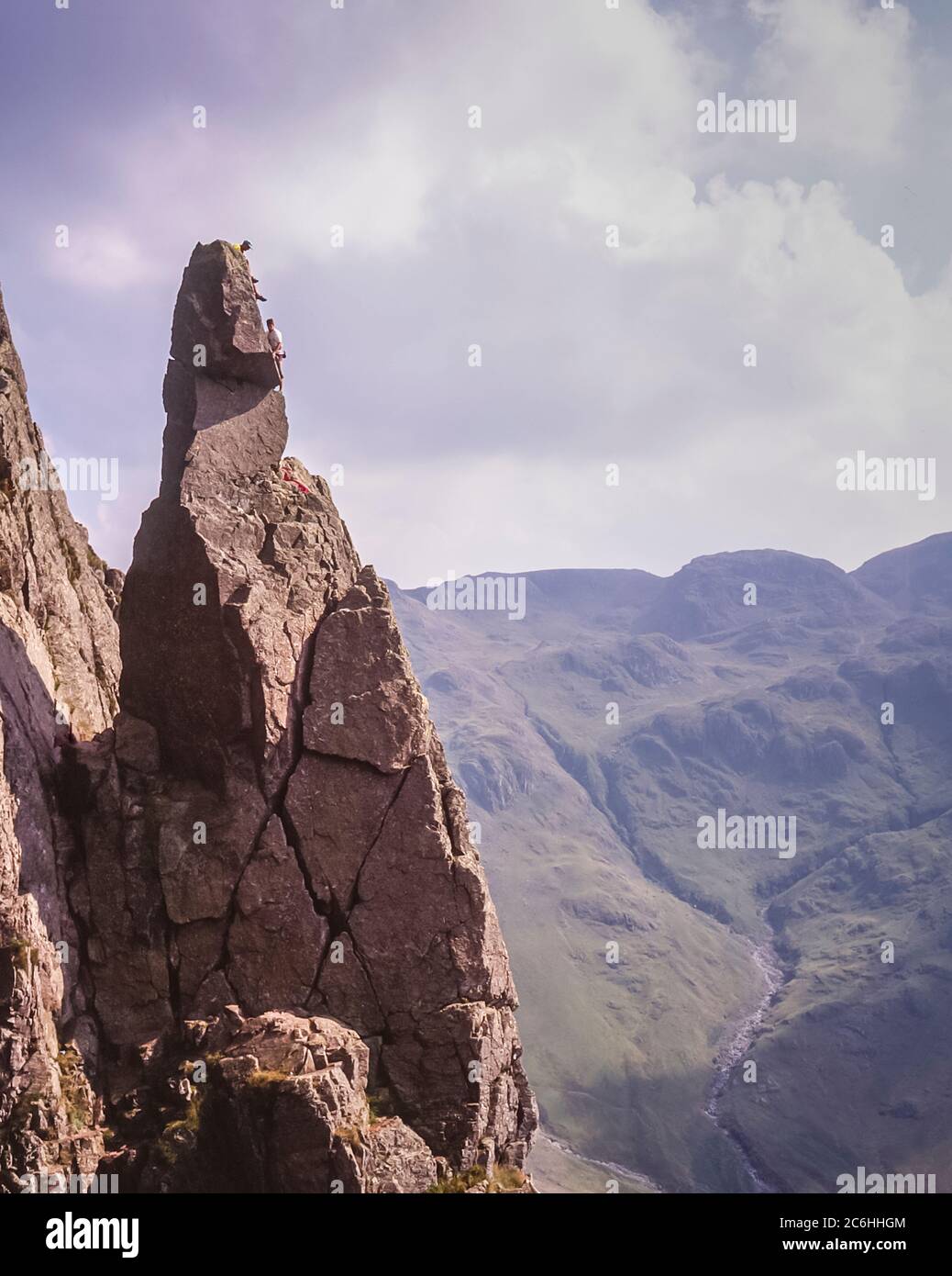 The image shows rock climbers in action scaling the Napes Needle rock ...