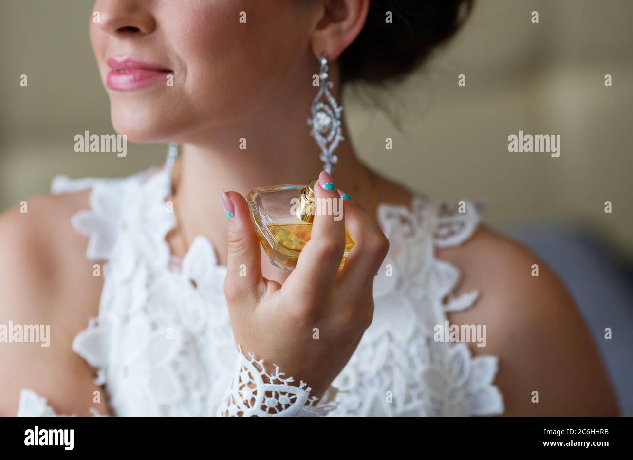 bride applying perfume. Bride spraying perfume on her neck Stock Photo ...