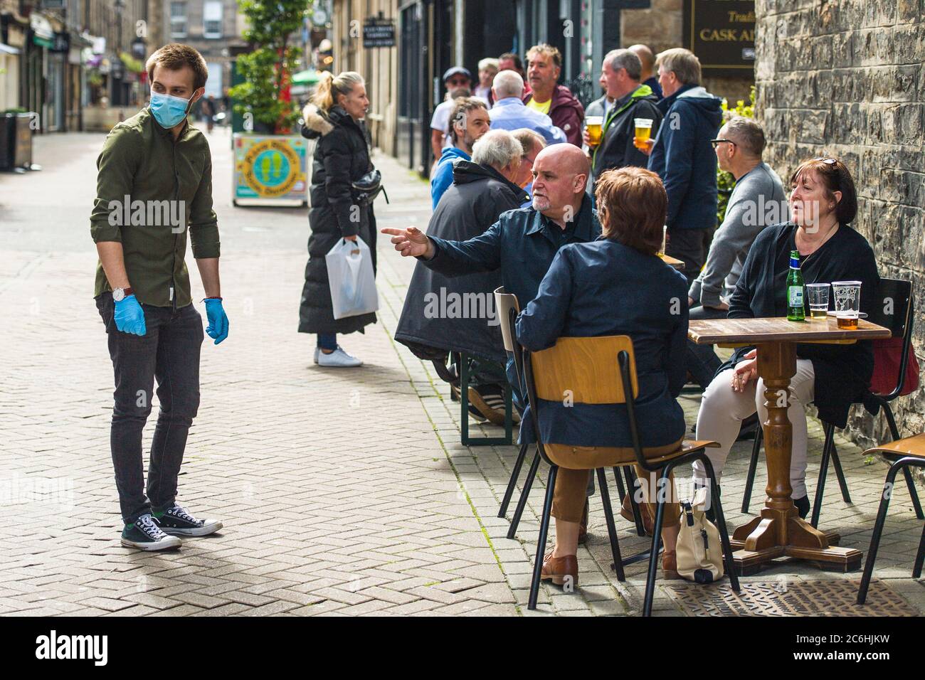 The public enjoy their first drinks from a pub at on Rose street, as ...