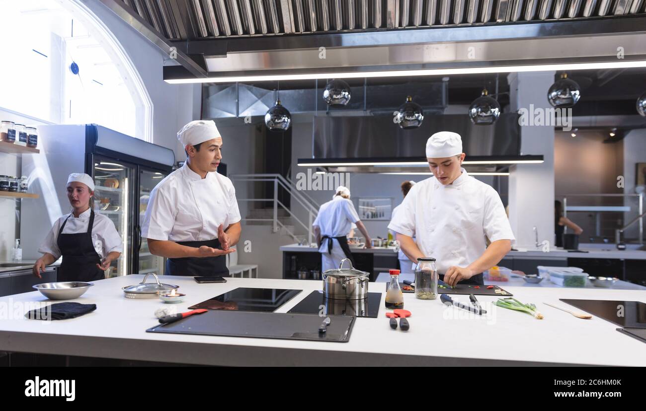 Group of chefs working at restaurant kitchen Stock Photo - Alamy