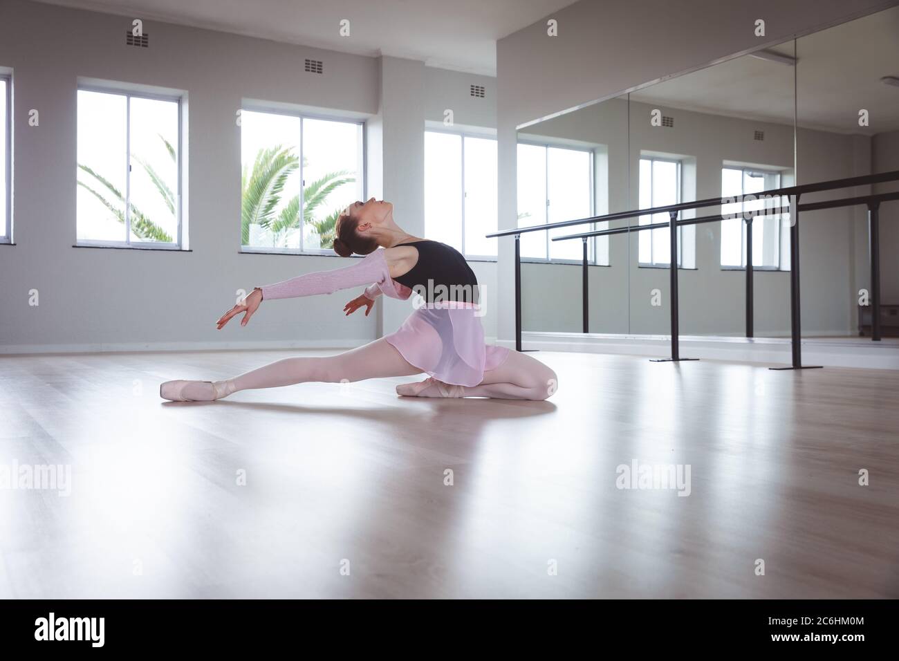 Female ballet dancer stretching at ballet class Stock Photo - Alamy