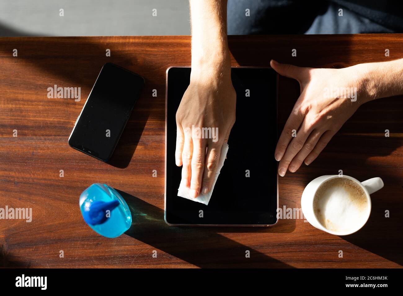 Mid section of woman cleaning her digital tablet Stock Photo - Alamy