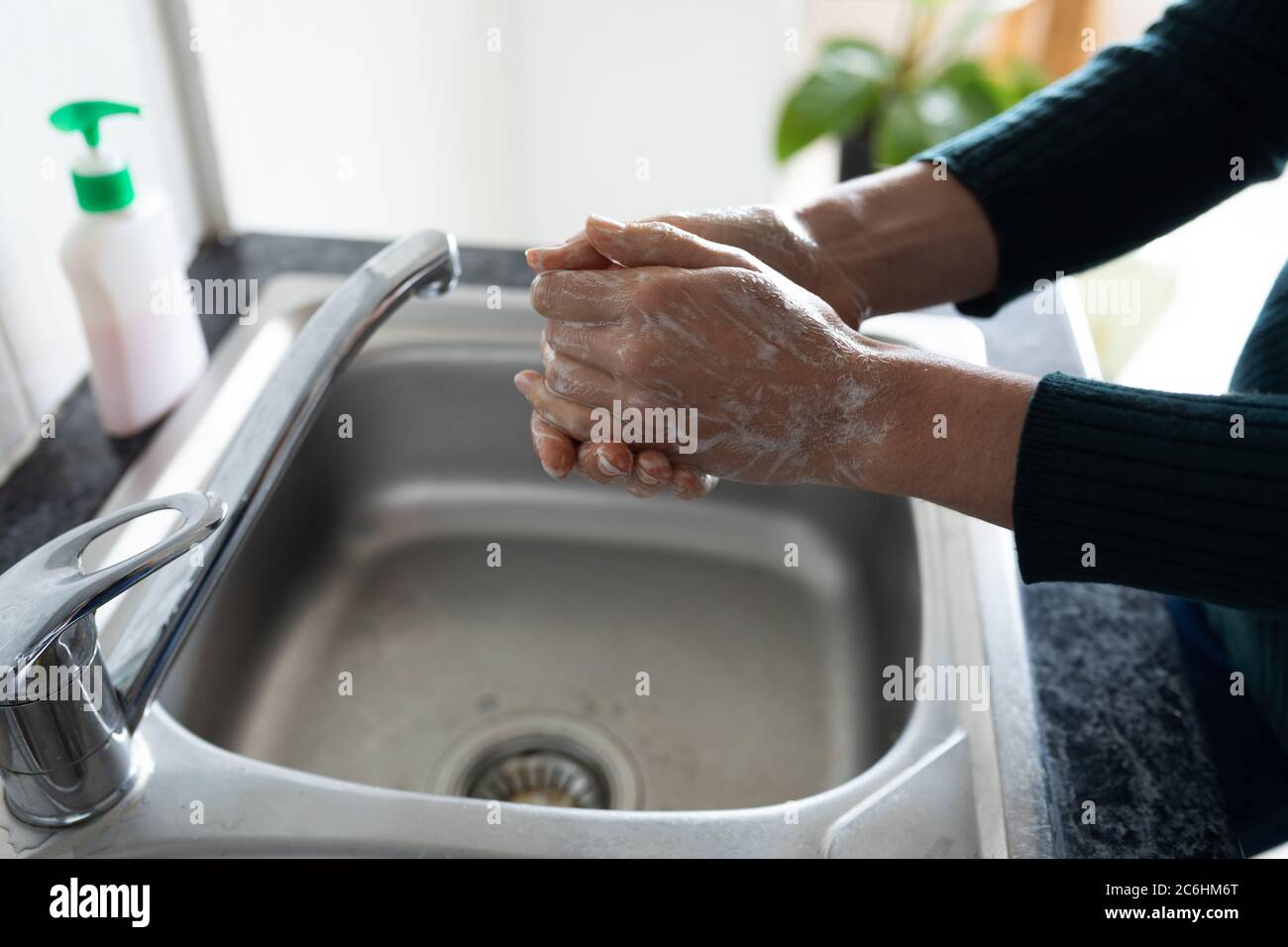 Woman using hand wash at home Stock Photo - Alamy