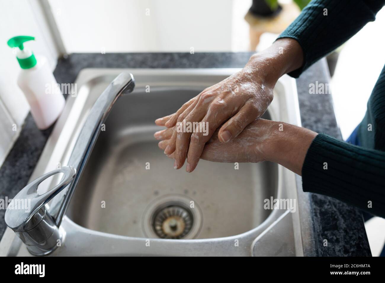 Mid section of woman washing her hands in the sink Stock Photo - Alamy