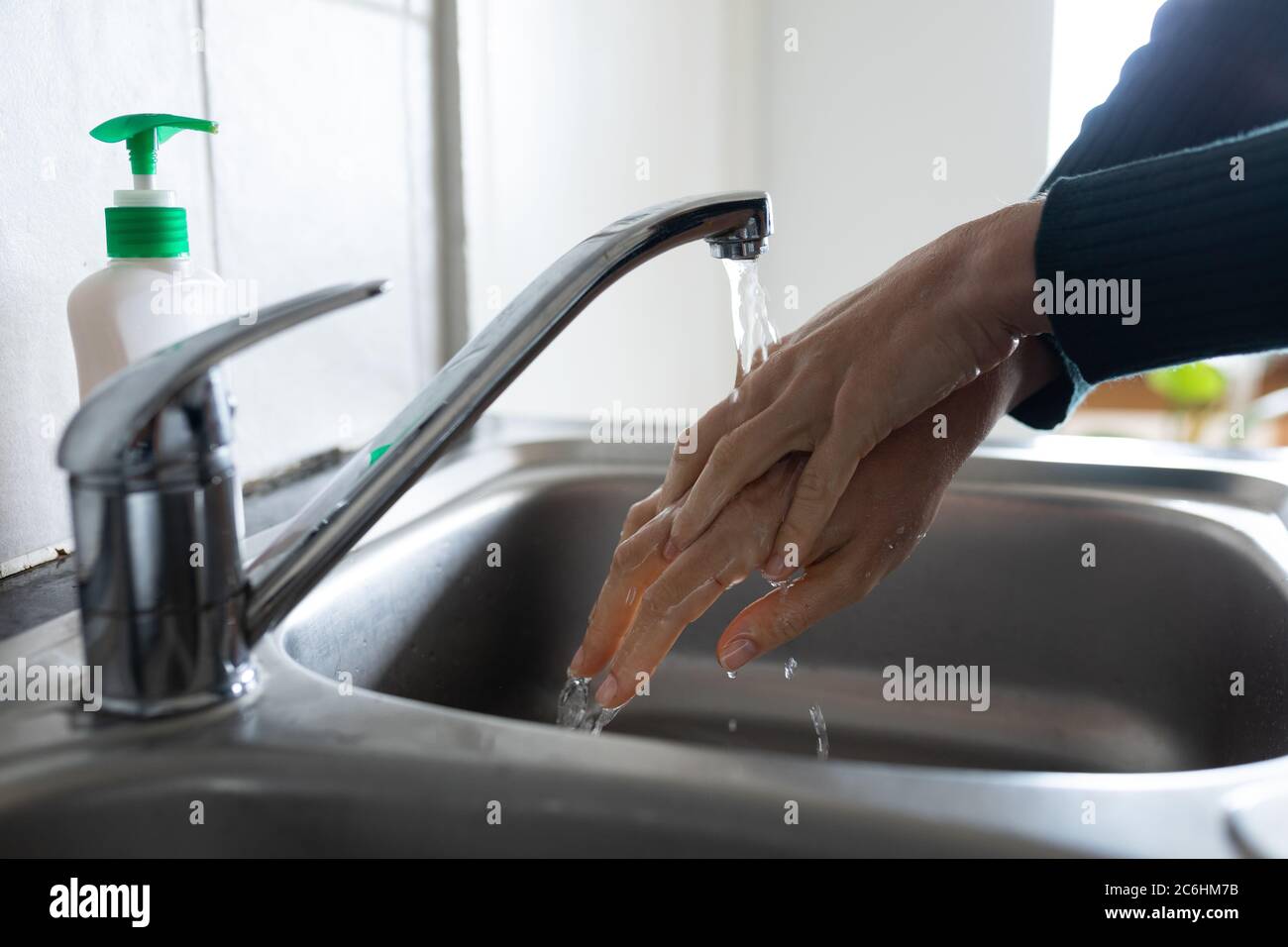 Mid section of woman washing her hands in the sink Stock Photo - Alamy