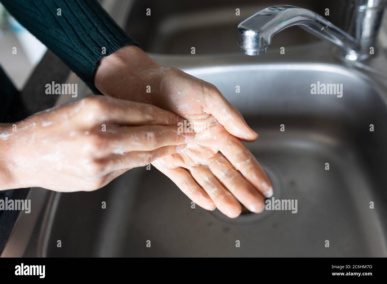 Mid section of woman washing her hands in the sink Stock Photo - Alamy