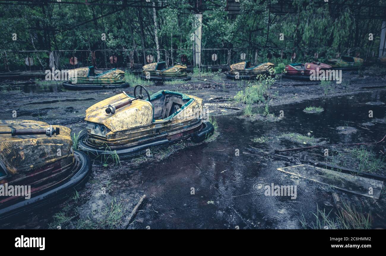 Broken metal radioactive cars in amusement park in Pripyat, the ...