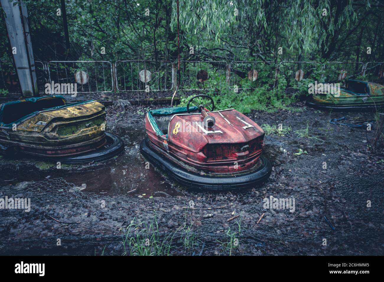 Broken metal radioactive cars in amusement park in the city of Pripyat ...