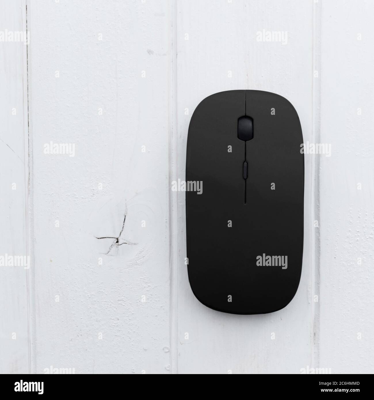 Black computer mouse on a wooden background, top view Stock Photo - Alamy