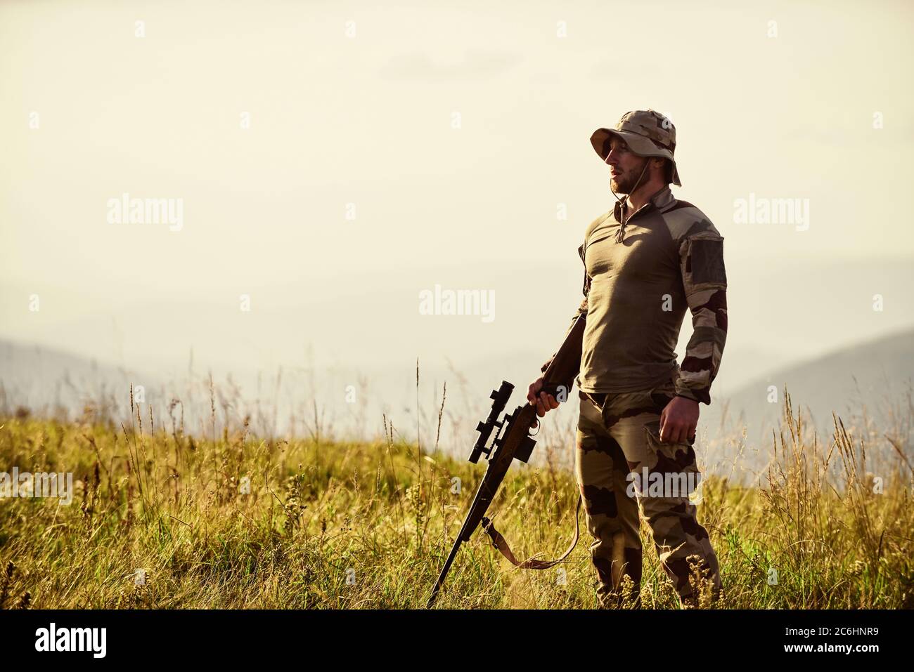 Focus and concentration experienced hunter. Brutal warrior. Rifle for ...