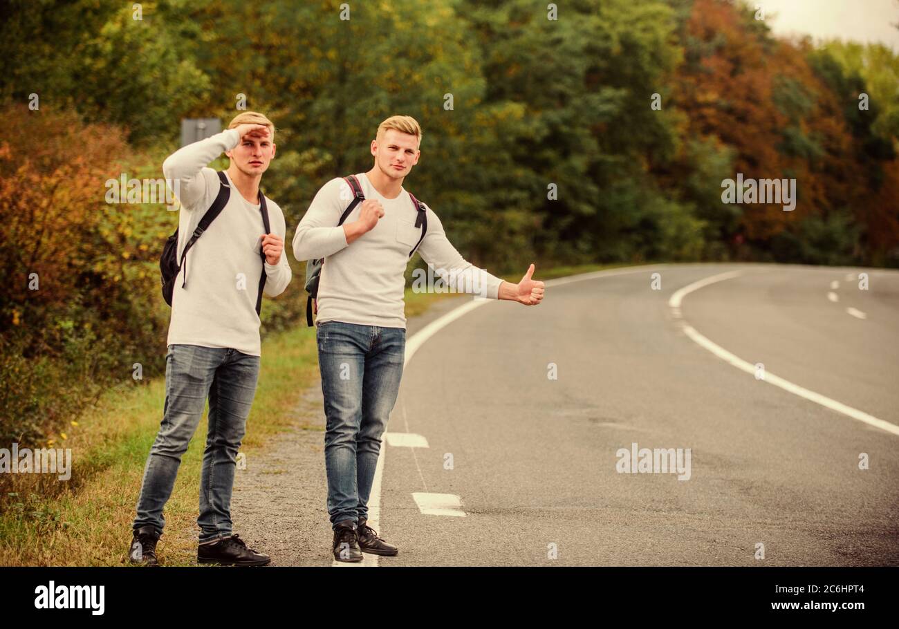 Travel and transport concept. Twins men at edge of road nature ...