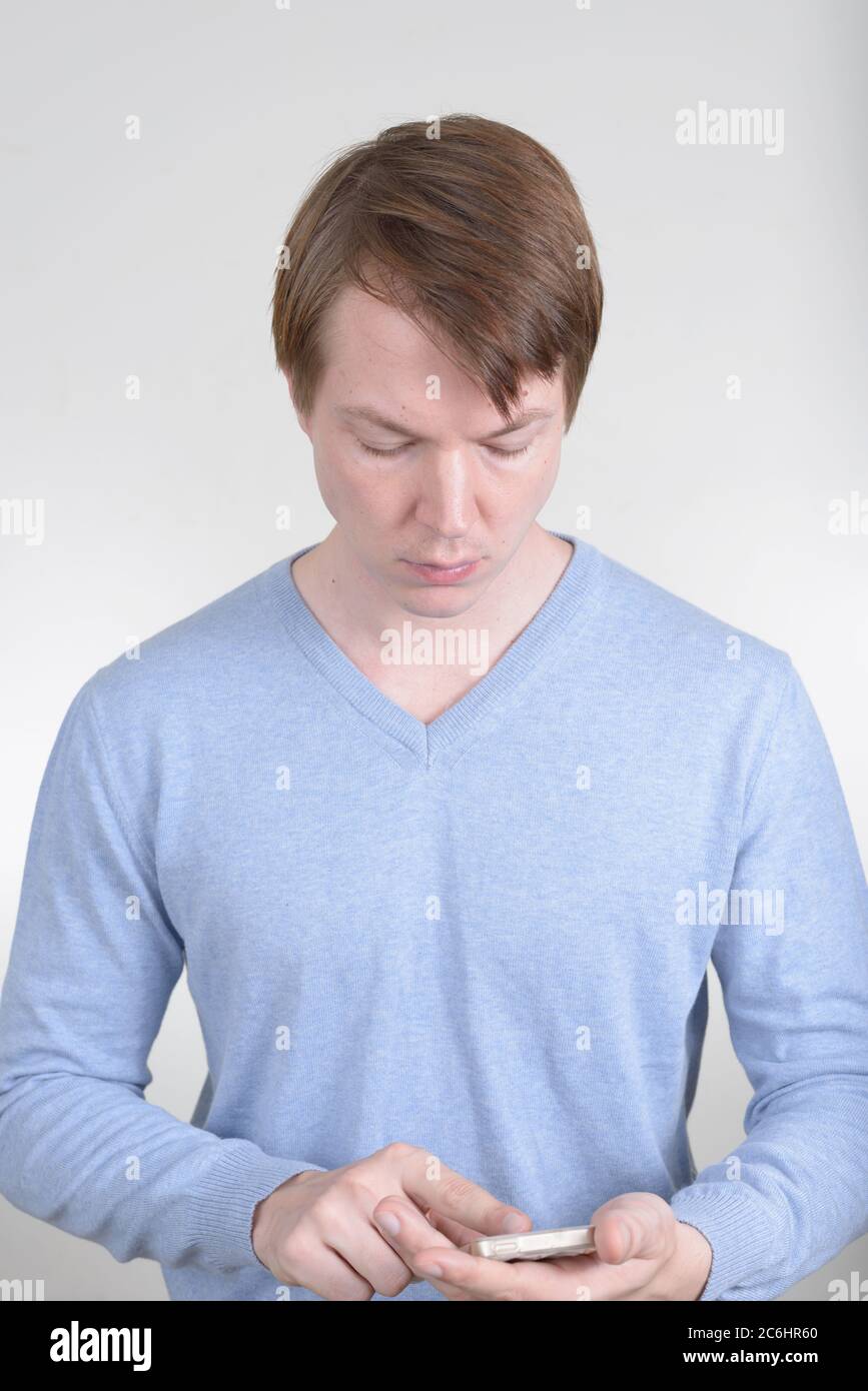 Portrait of young handsome man using phone Stock Photo - Alamy