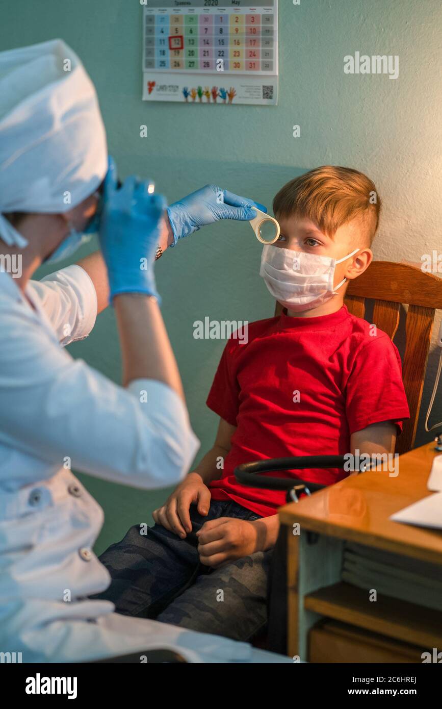 Doctor optometrist checks preschool boy's eyesight. City Hospital ...