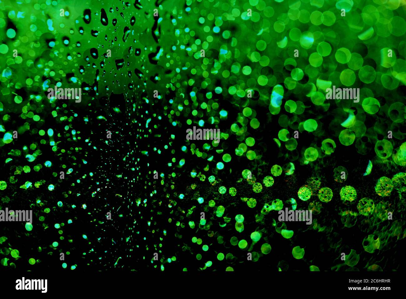 Water drop through a window. glowing green particles Stock Photo - Alamy