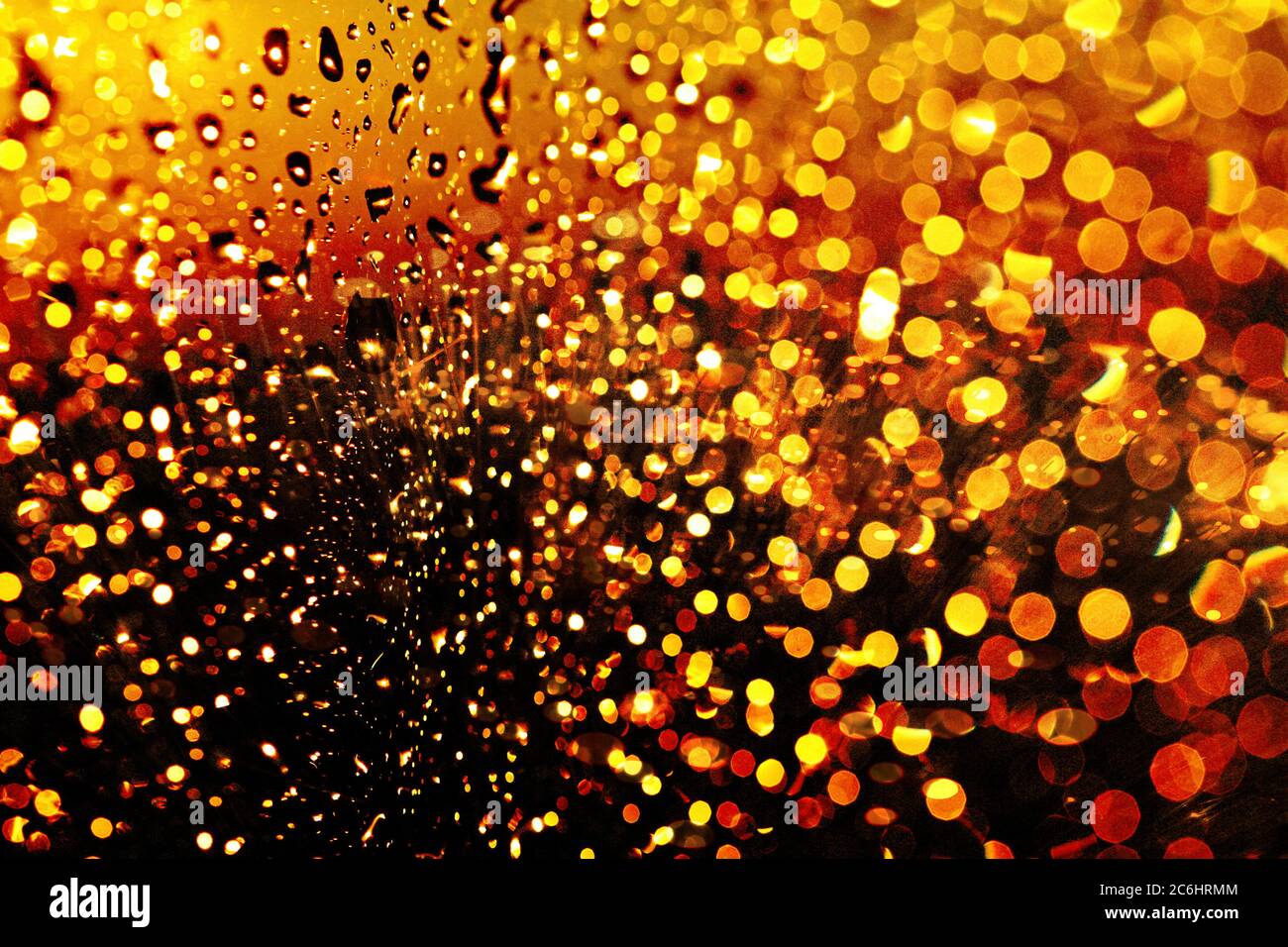 Rainy water drop through a window. glowing golden particles Stock Photo ...
