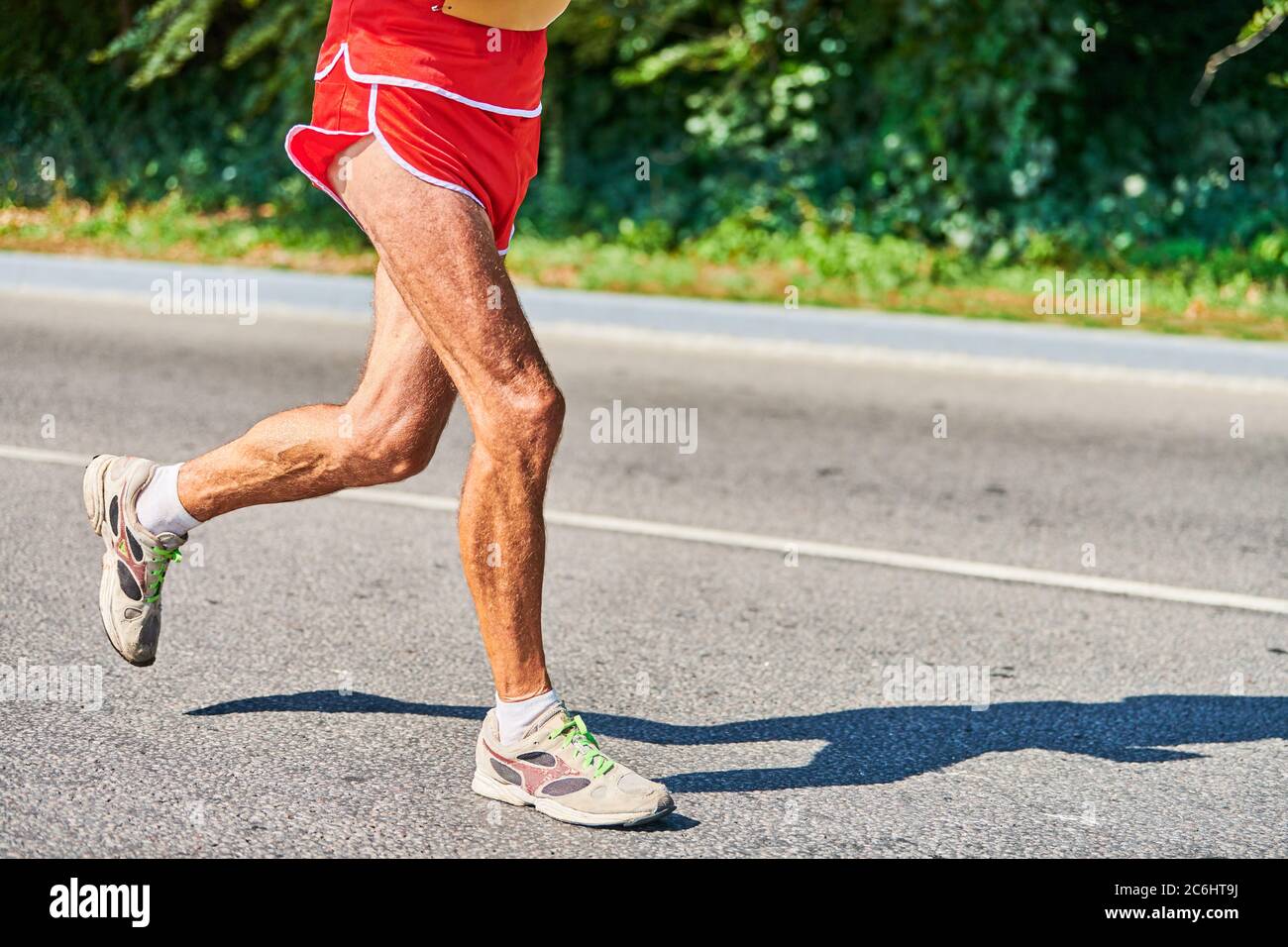 Running old man. Old man jogging in sportswear on city road. Healthy ...