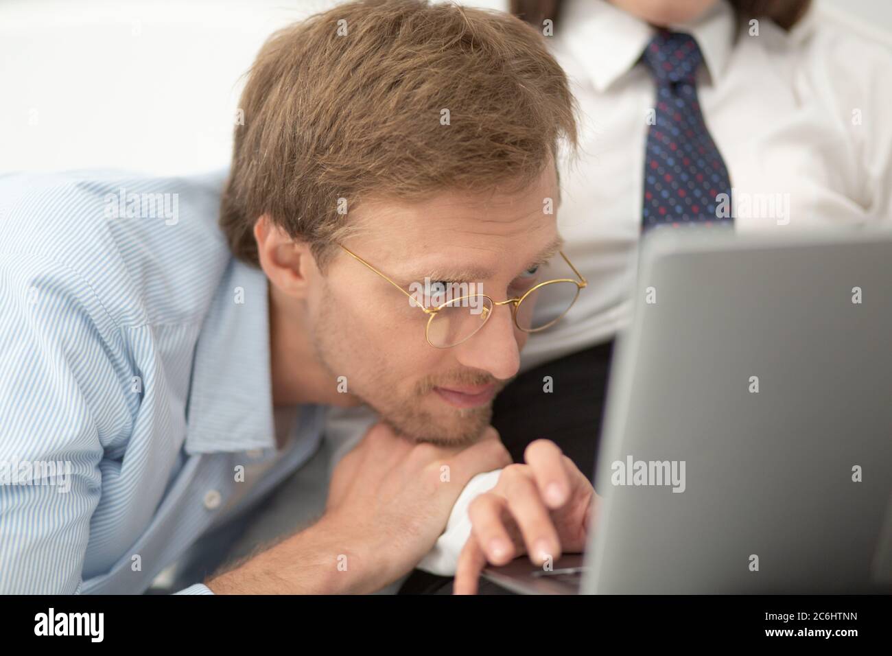 Man watching his wife work on computer. Close up portrait of man ...